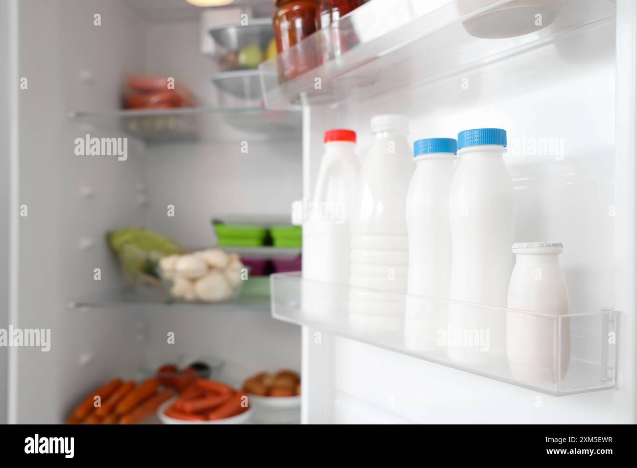 Bottles of fresh milk on fridge door. Closeup Stock Photo - Alamy