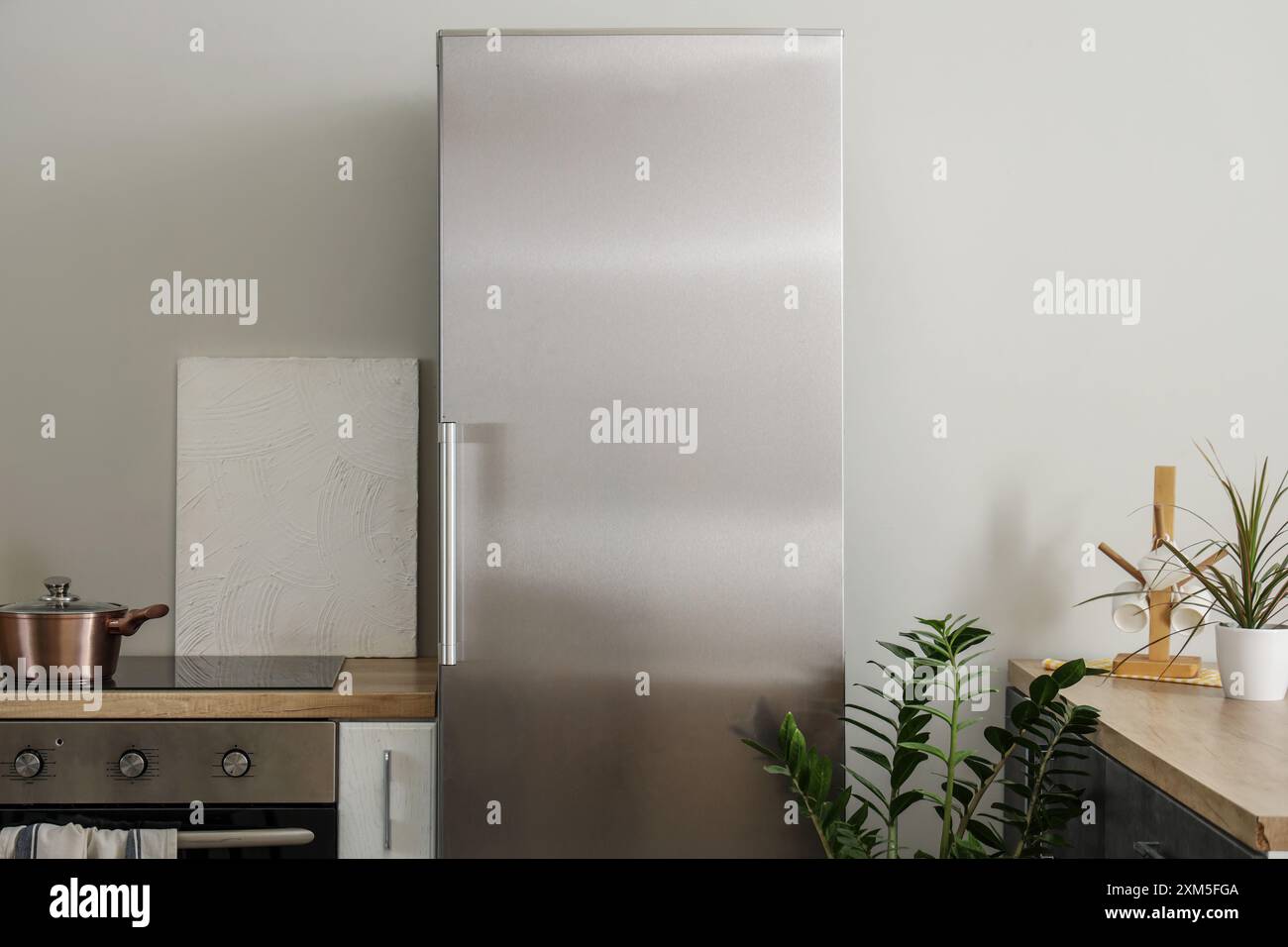 Modern fridge in interior of kitchen Stock Photo - Alamy