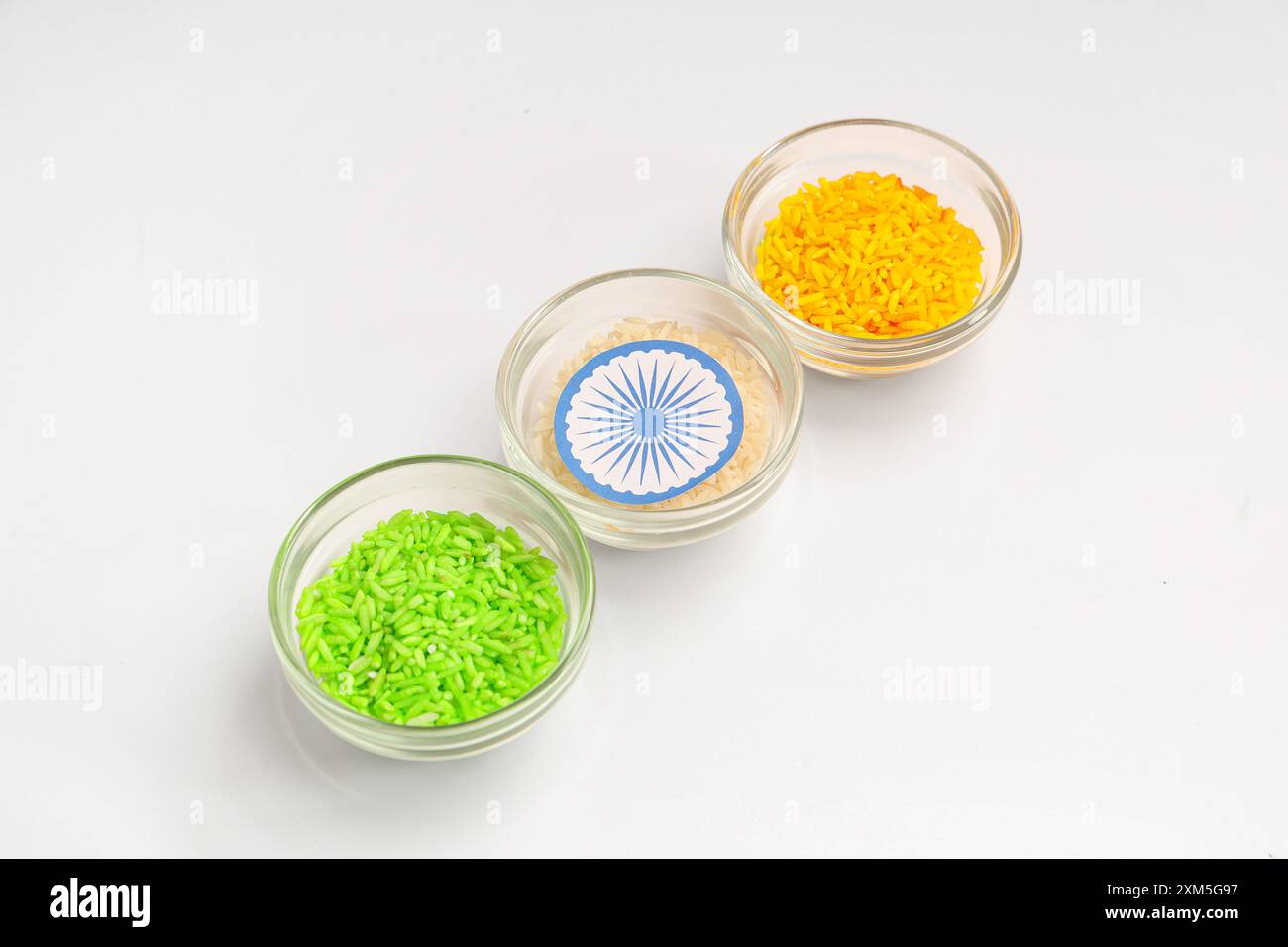 Bowls with colorful rice in colors of Indian flag on white background ...