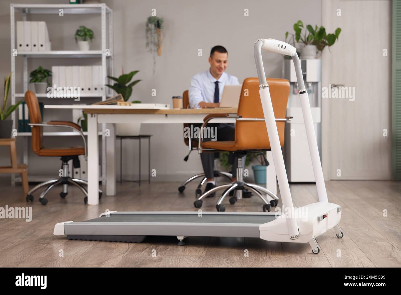 Modern treadmill of working businessman in office Stock Photo - Alamy