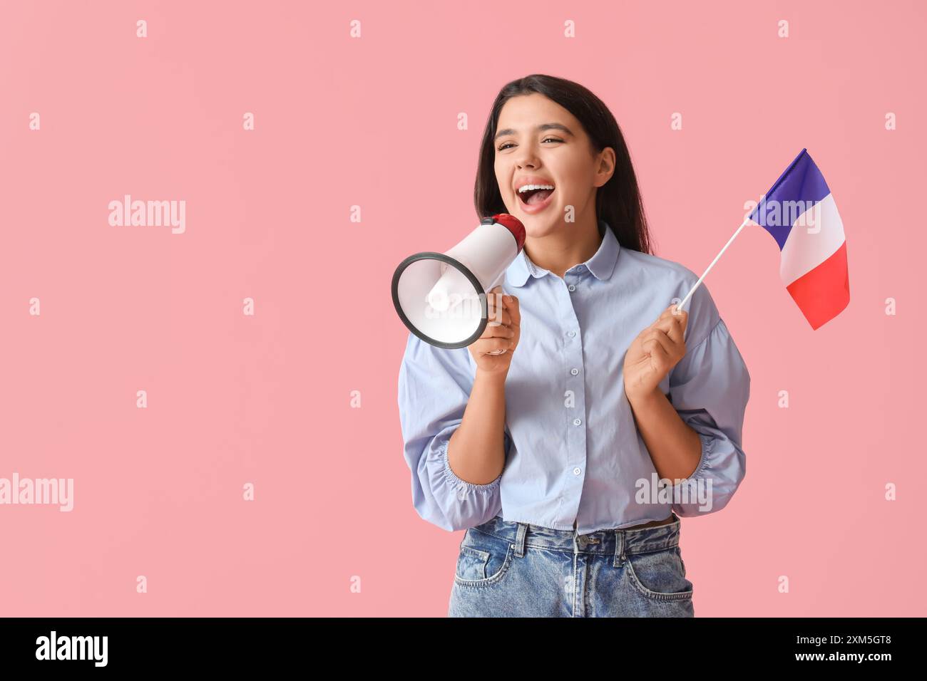 Female French language teacher with megaphone and flag on pink ...