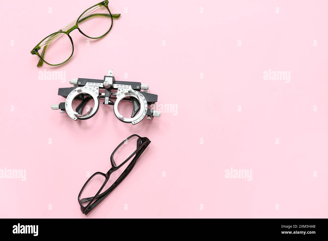 Optical trial frame with eyeglasses on pink background Stock Photo - Alamy