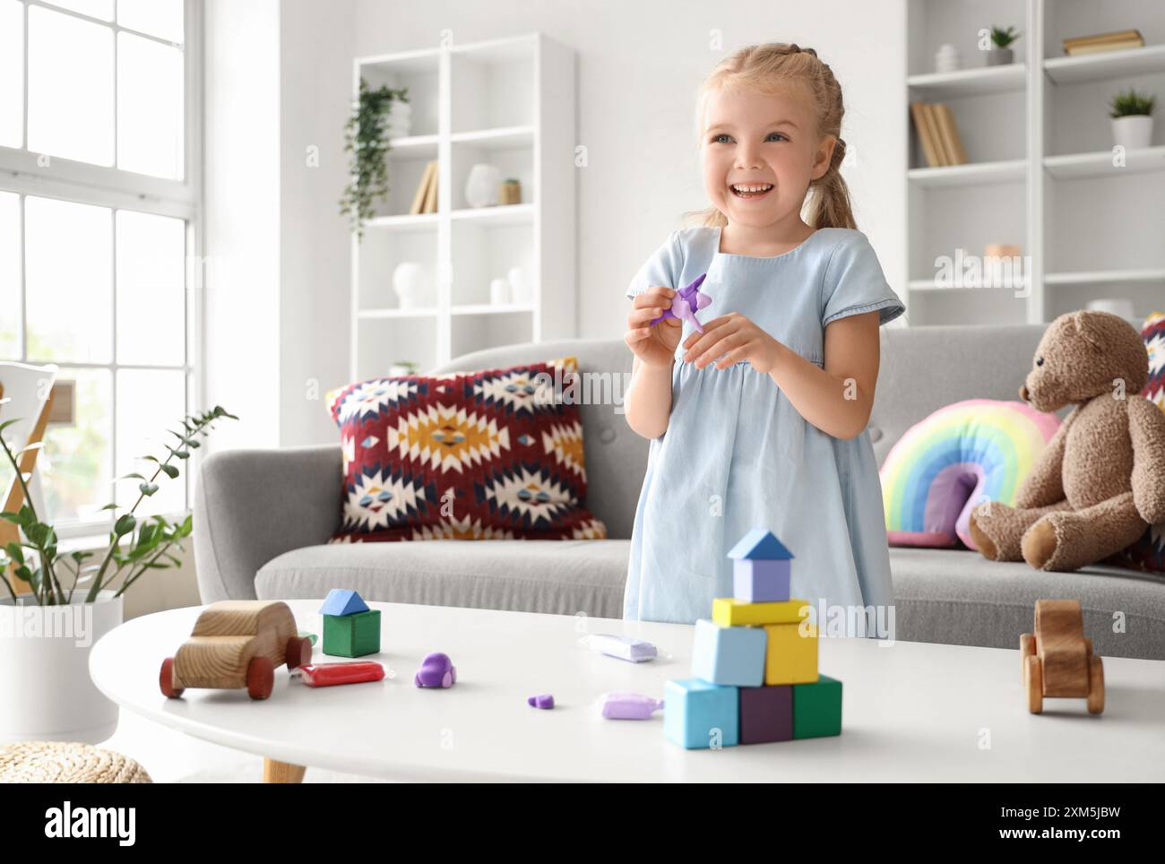 Cute little girl sculpting from plasticine at home Stock Photo - Alamy
