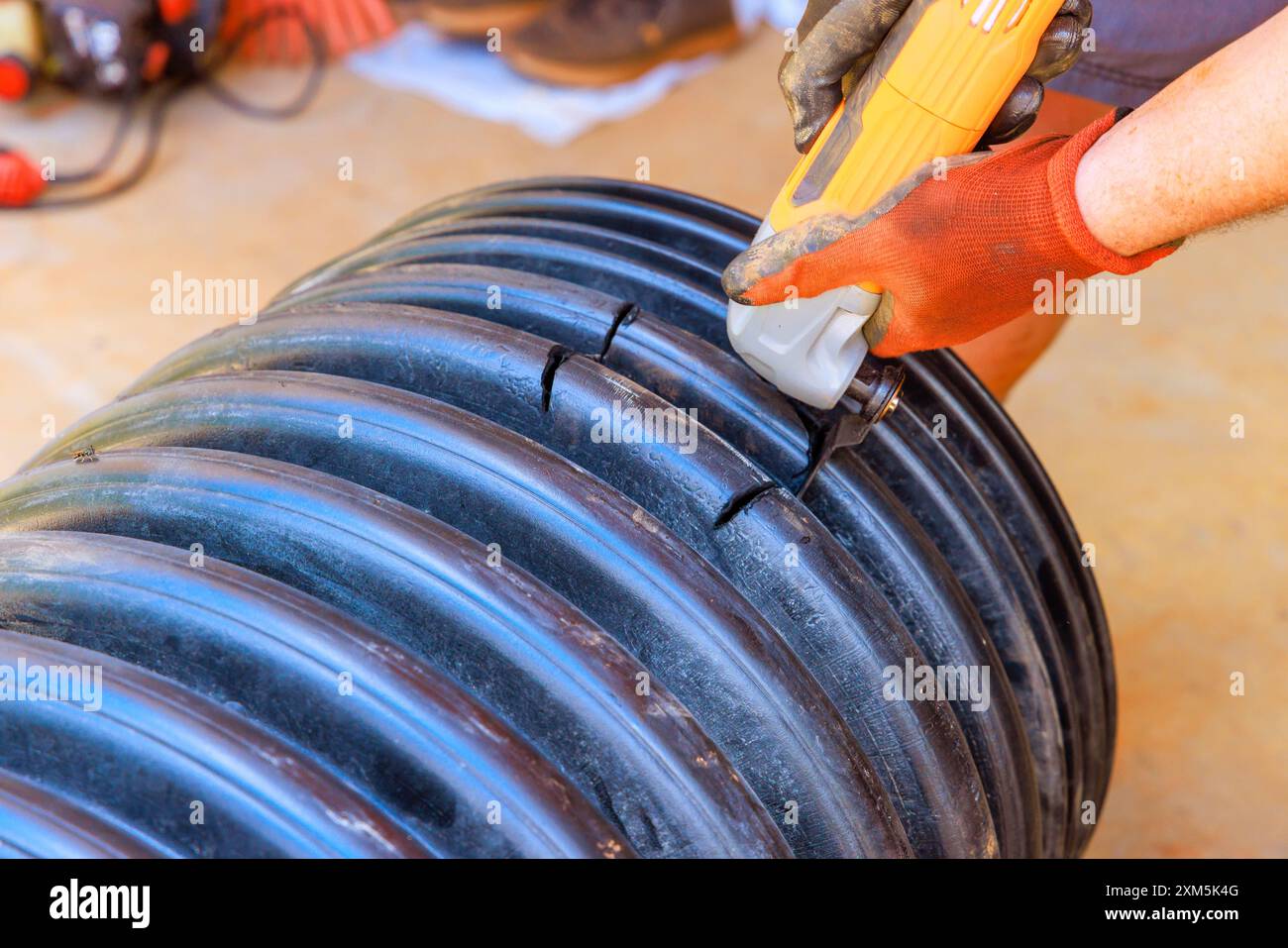 To connect two pipes, hole must be cut in black plastic polypropylene ...