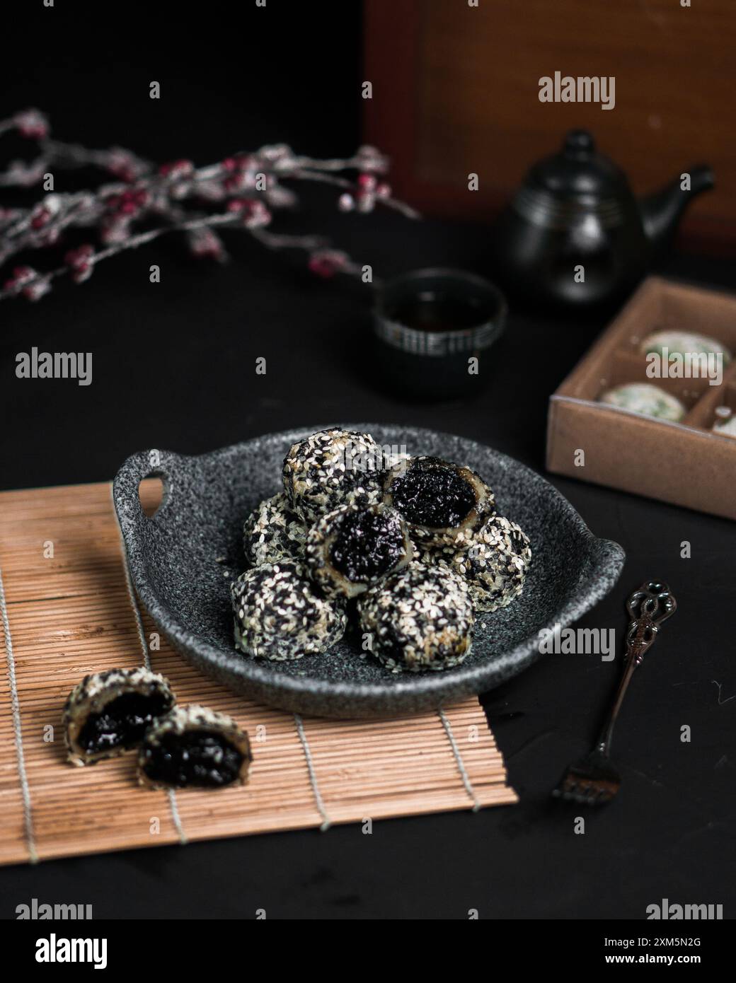 a plate of mochi with black sesame seeds on it Stock Photo - Alamy