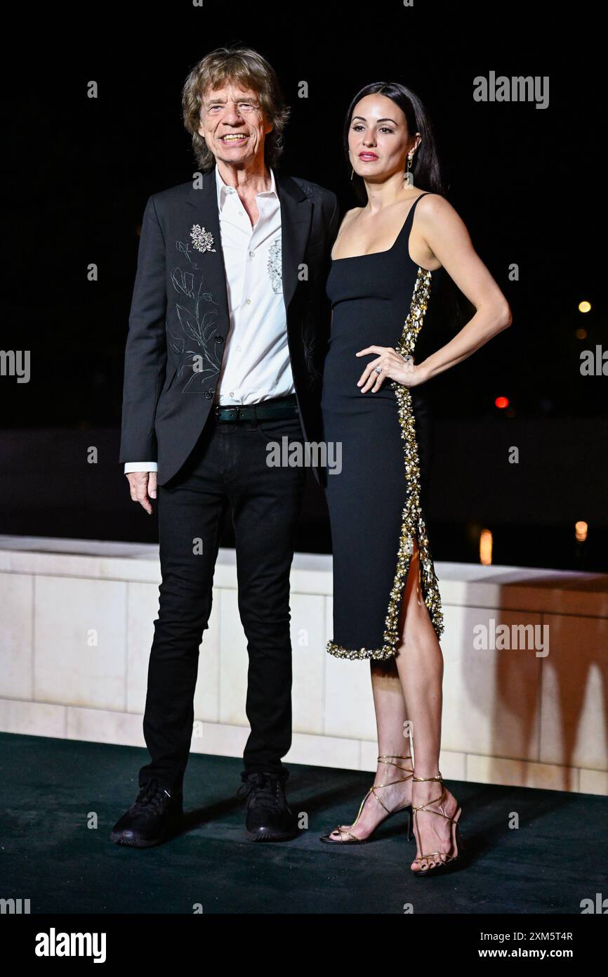 Mick Jagger and Melanie Hamrick posing for photos on the red carpet at The Prelude to the ...