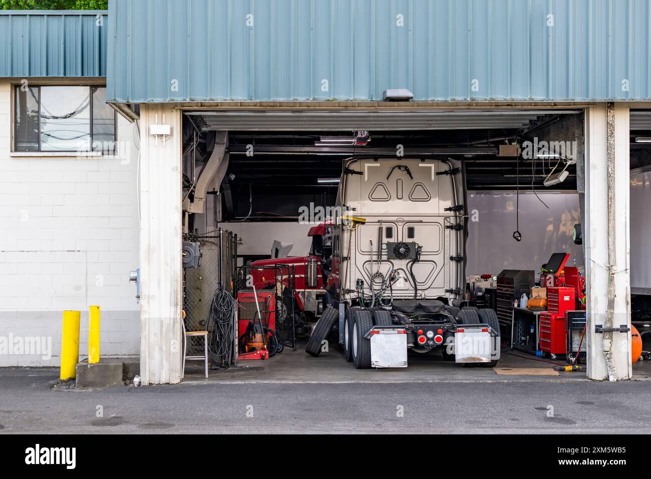 Industrial grade white big rig semi truck with open hood with a ...
