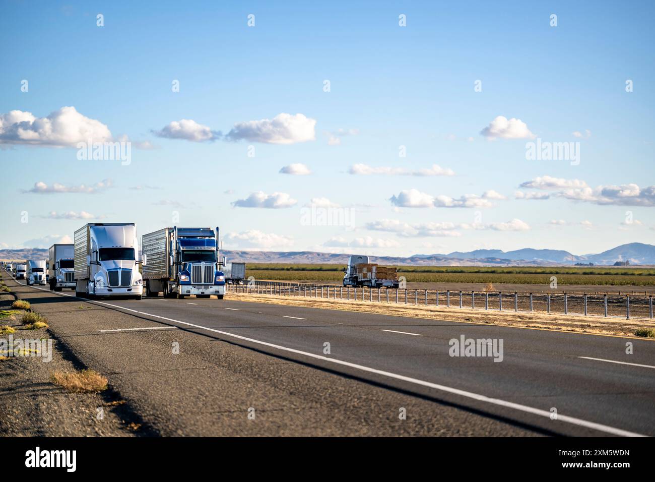 Convoy of the industrial carriers long haulers big rig semi trucks with ...