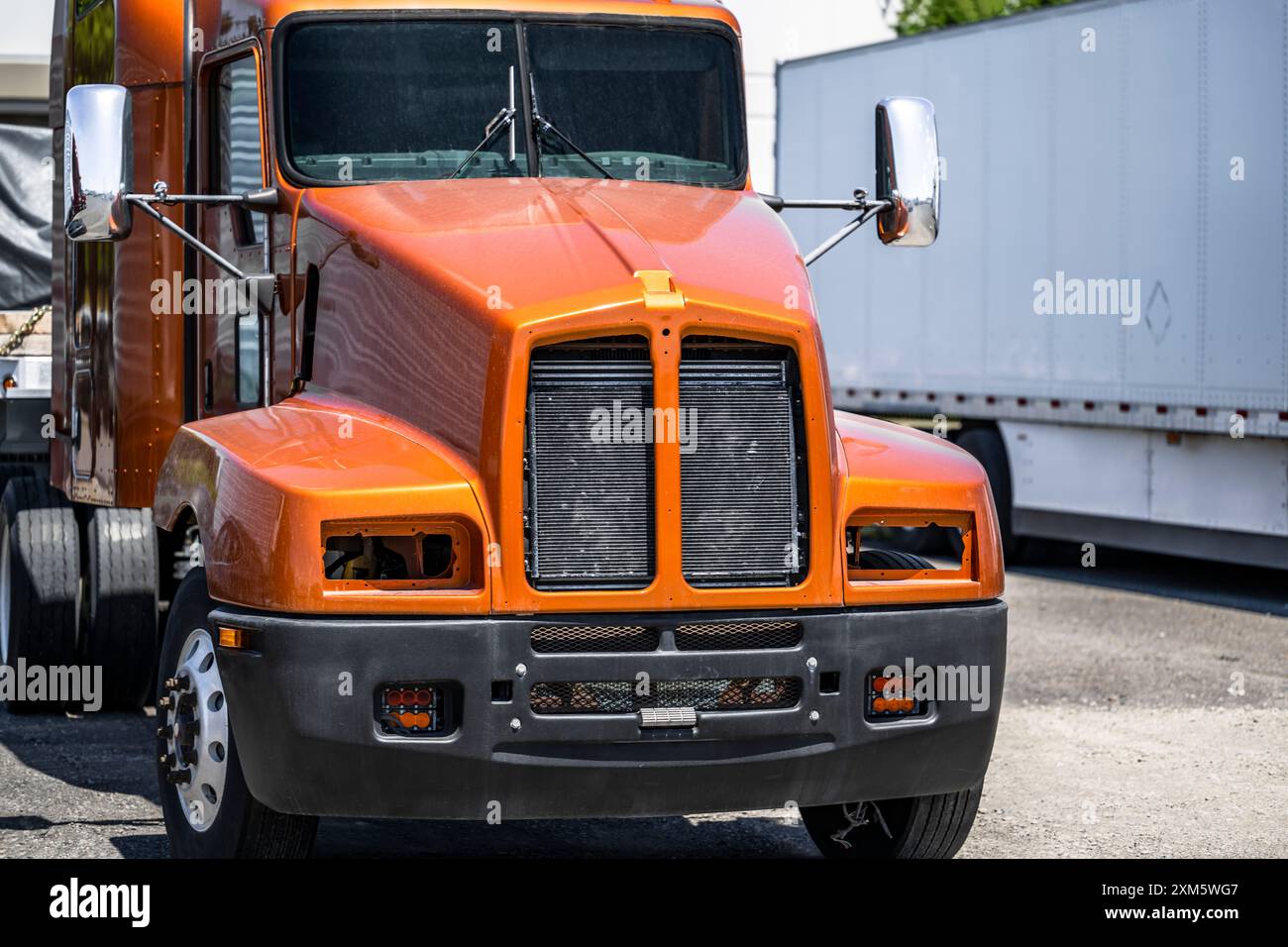 Industrial grade freshly painted after repair orange big rig semi truck ...