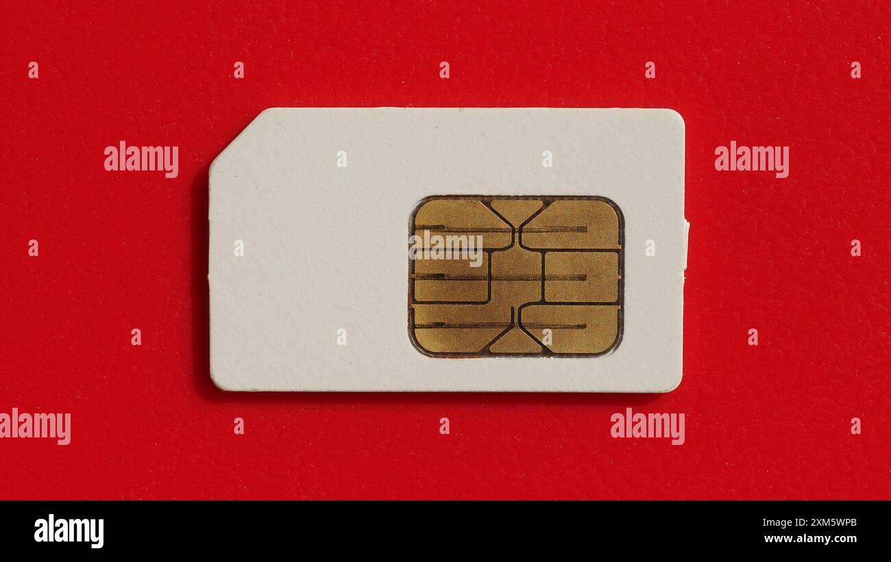blank mobile phone sim card over red background Stock Photo - Alamy