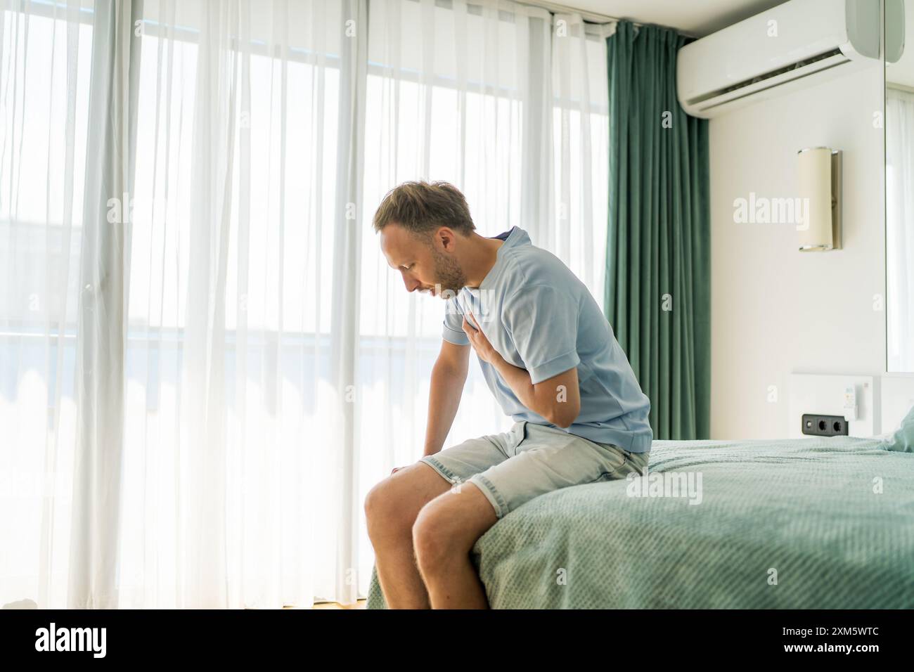 Man suffering heart attack clutching chest. Sudden chest pain ...