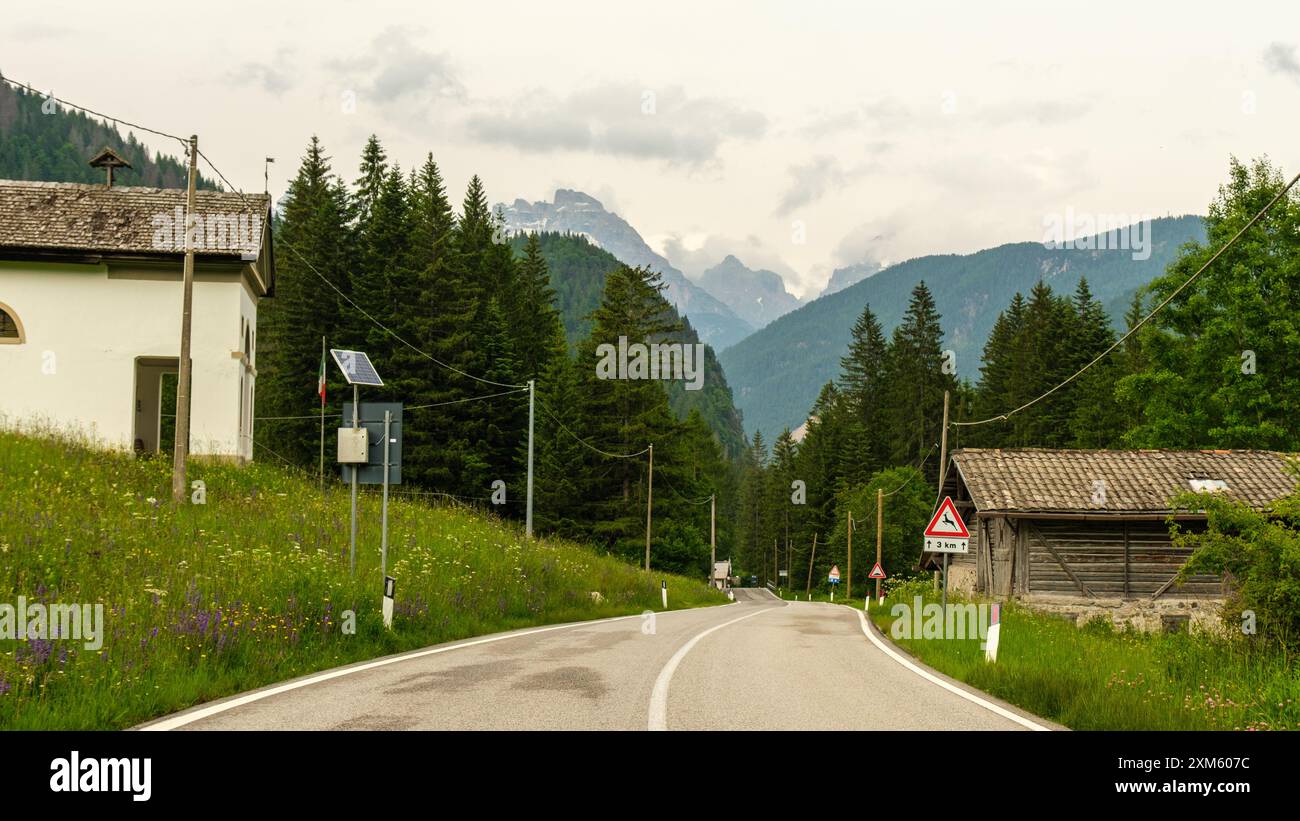 A paved road runs parallel to the majestic Cimon del Froppa, which ...