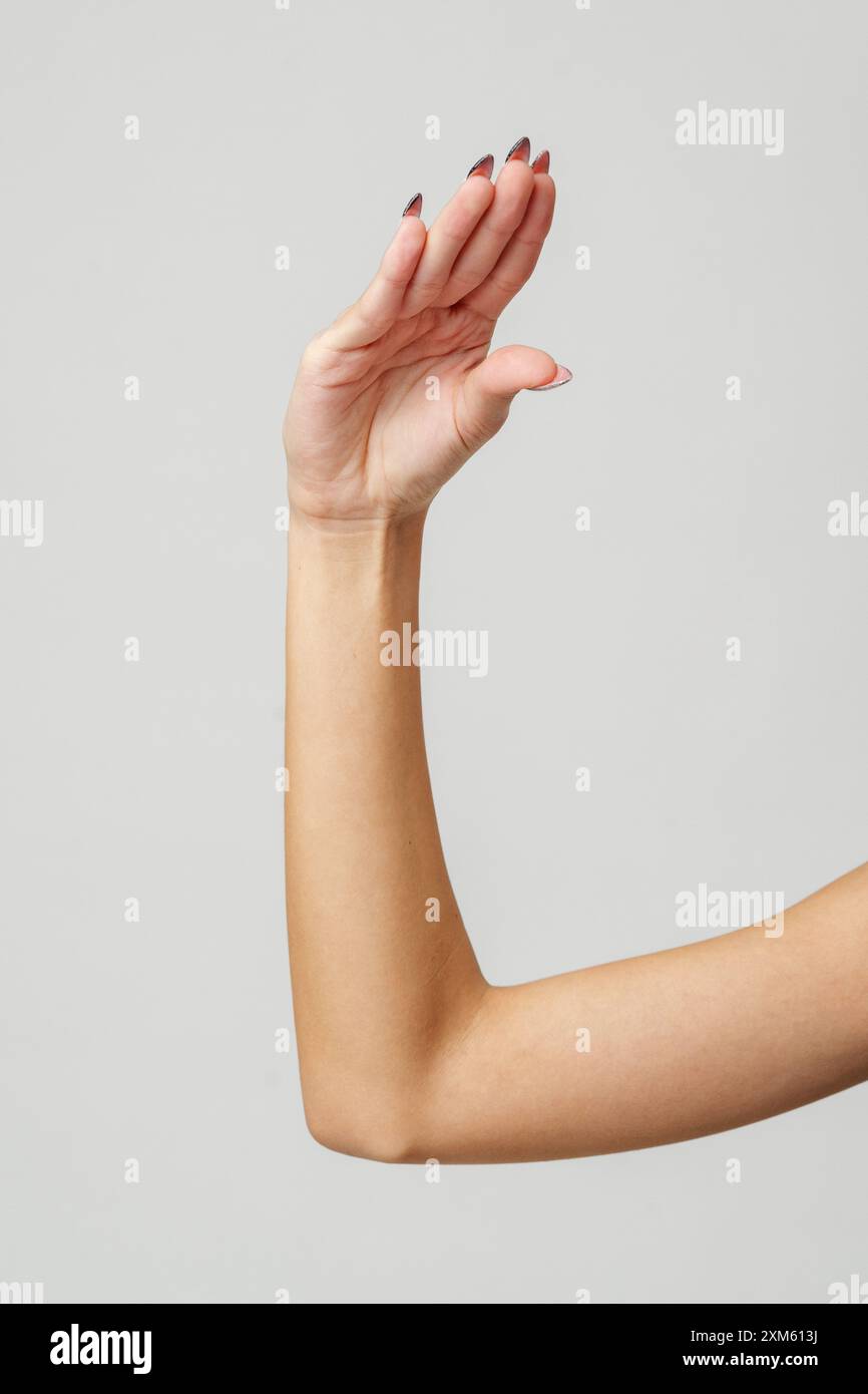 Woman's Arm Extended With Hand Open and Fingers Against a White ...