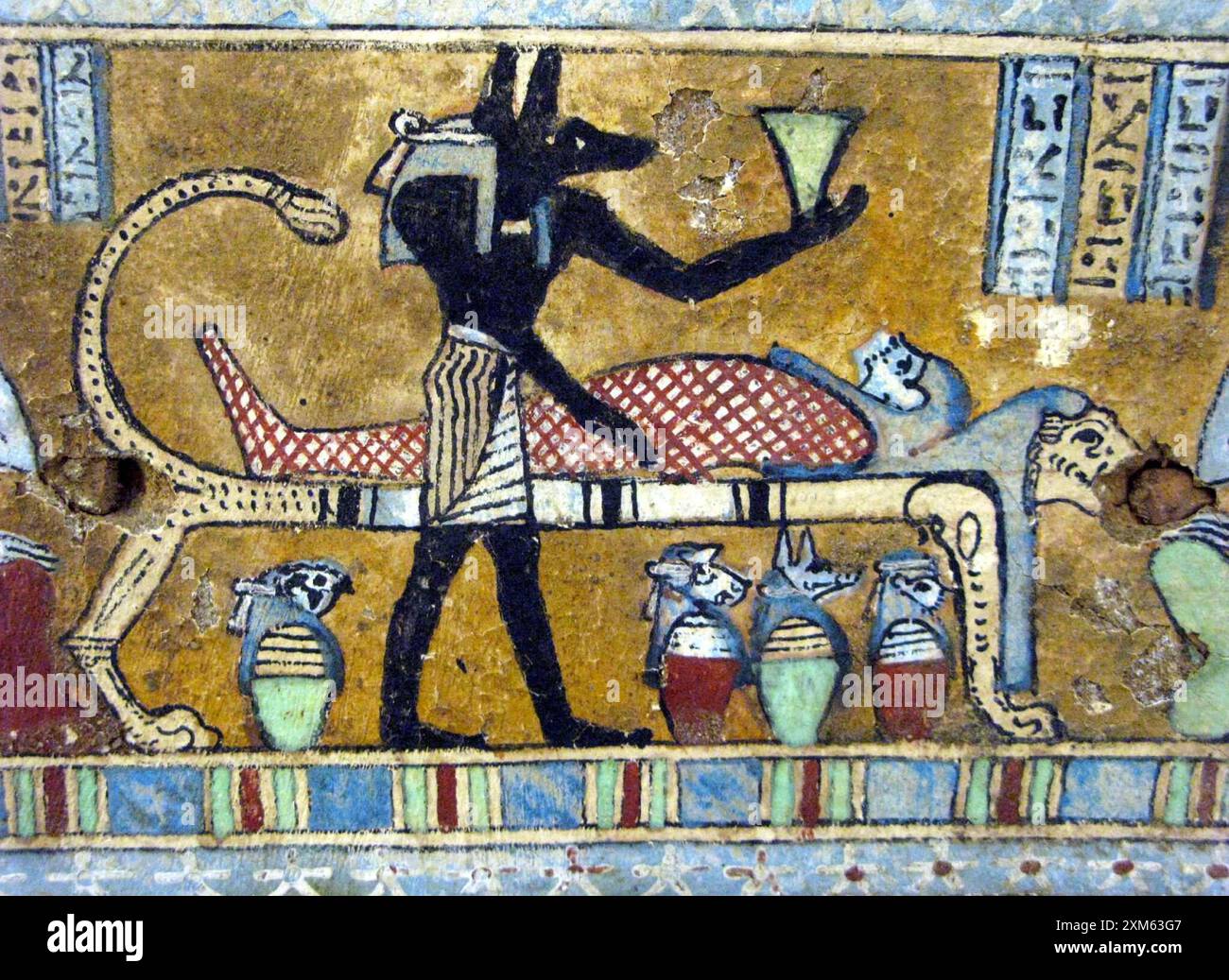 7268. A scene from a wooden Egyptian sarcophagus depicting Anubis, the ...