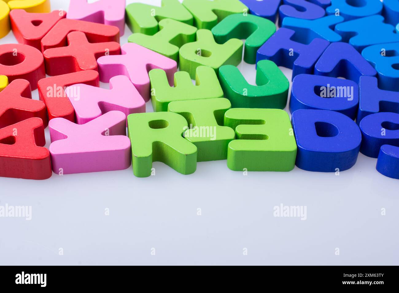 Colorful alphabet letter blocks scattered randomly on white background ...