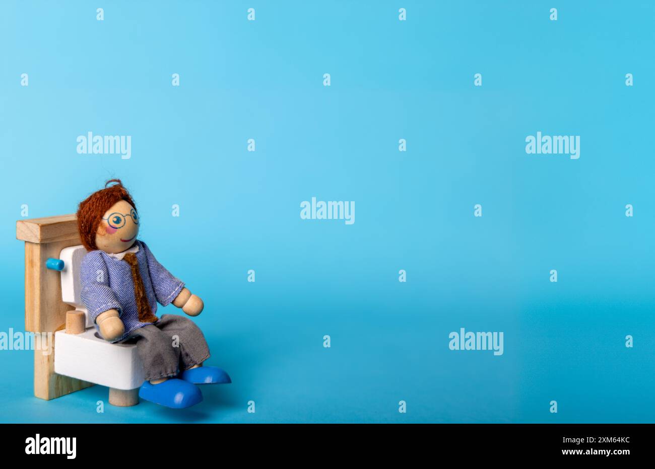 A wooden figure of a man on a toilet, creatively expressing love in a ...