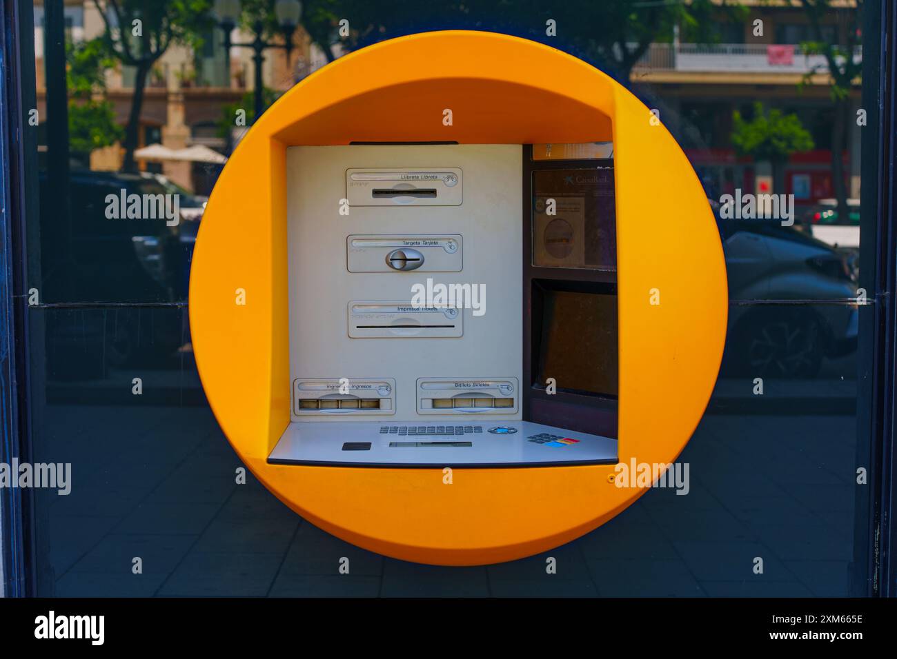 Tarragona, Spain - July 15, 2024: Bright yellow facial recognition ATM ...