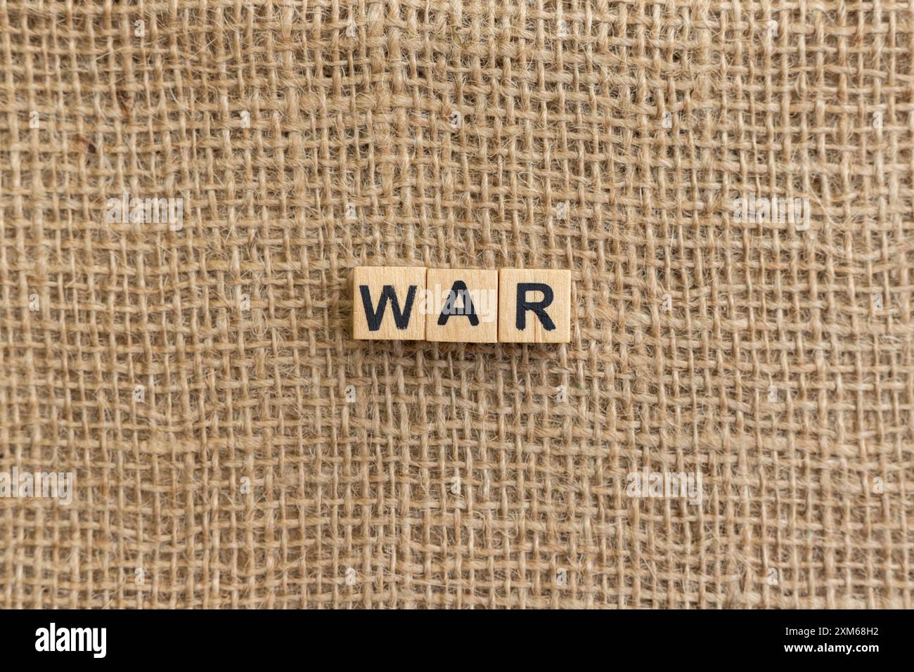 Wooden block cubes with WAR word on burlap background with copy space ...