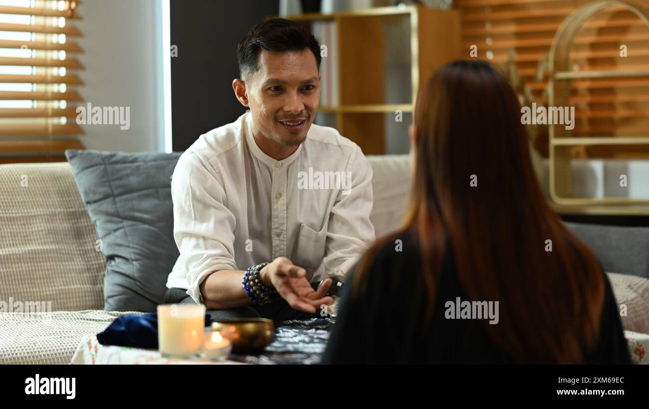 Male tarot reader forecasting predicting future for young woman client ...