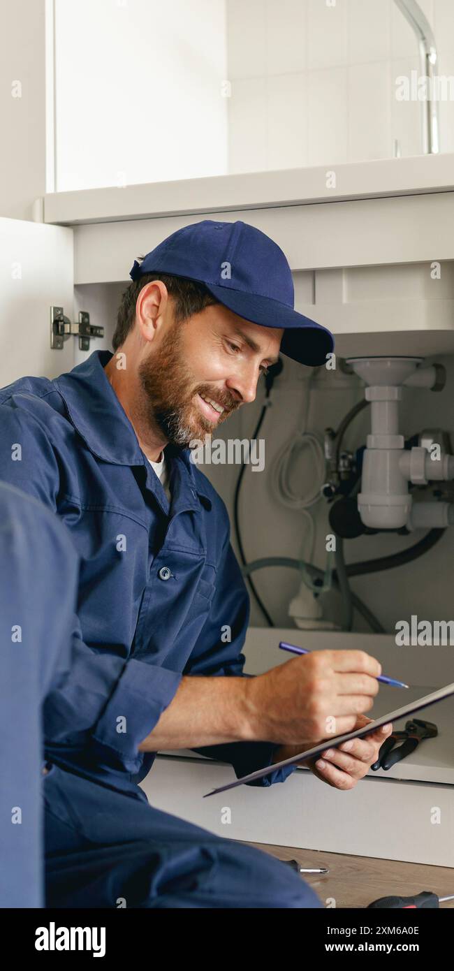 Professional plumber examine a siphon pipe on the kitchen sink after ...
