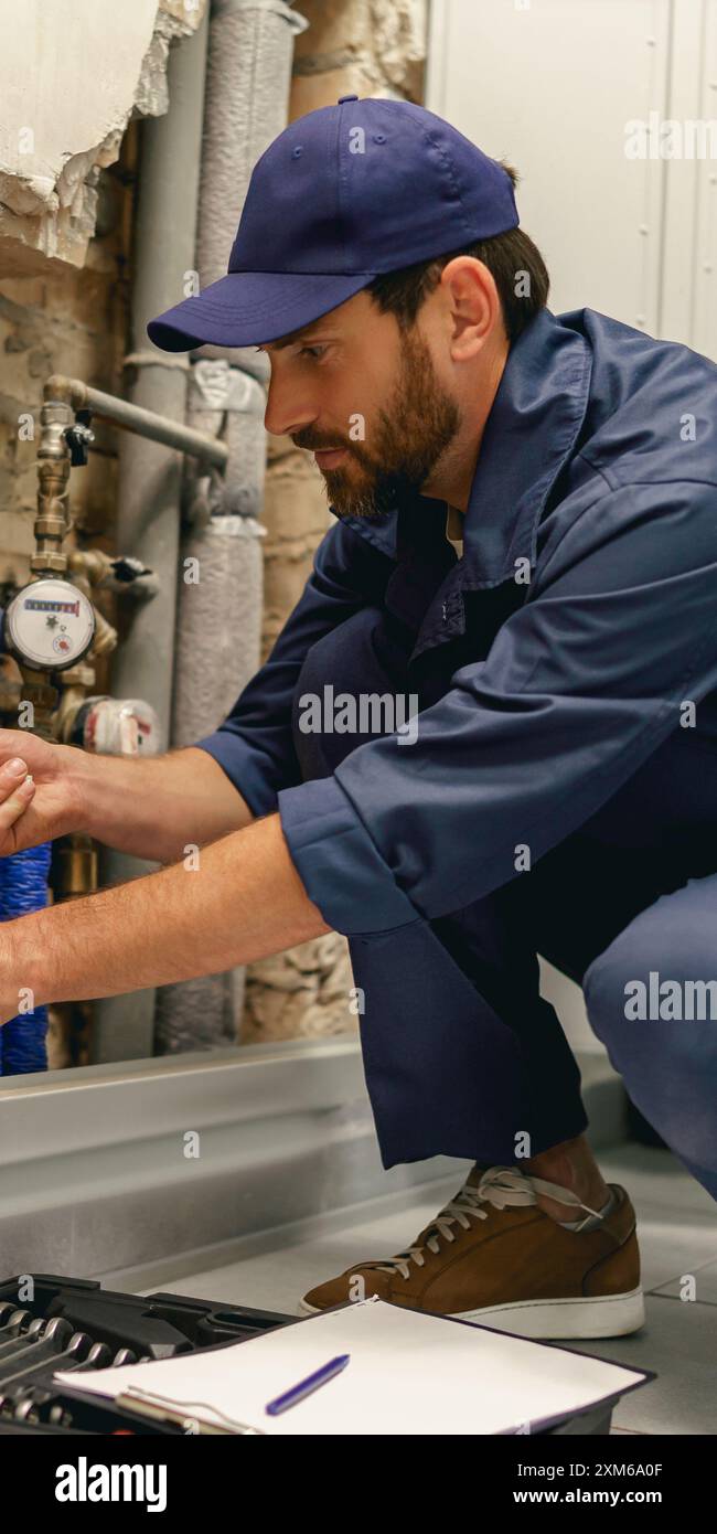 Professional plumber repairing water supply system at home uses an ...