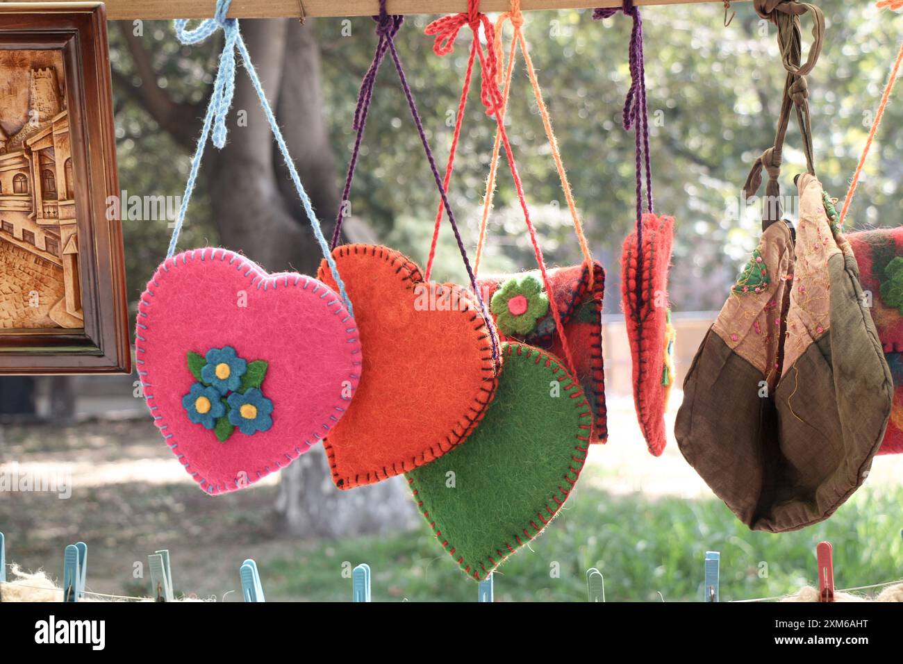 Heart shaped colorful hand bags for women outdoors Stock Photo - Alamy