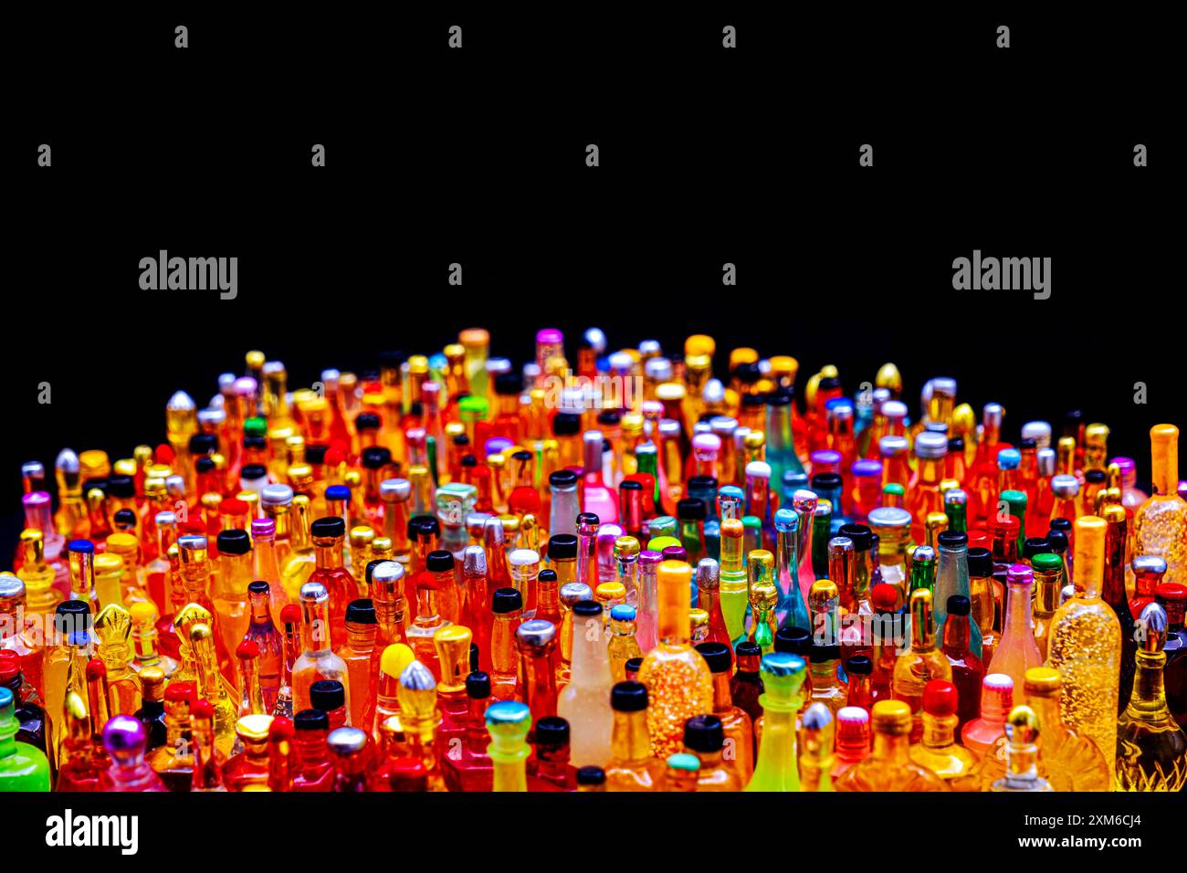 various miniature bottles of alcohol without labels with black ...