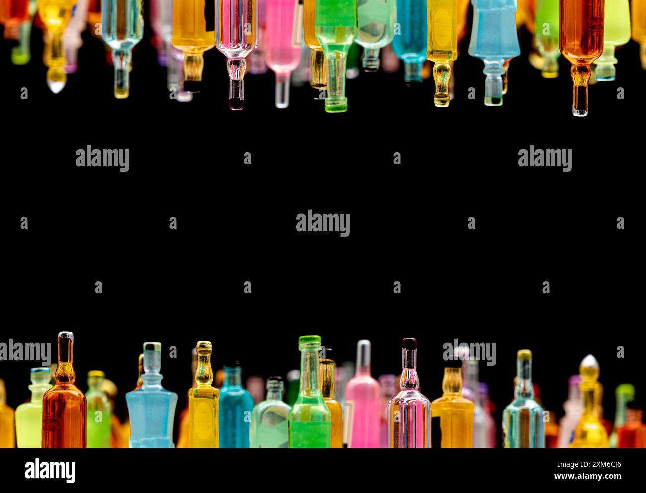 various miniature bottles of alcohol without labels with black ...