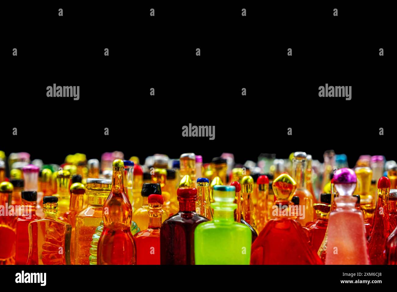 various miniature bottles of alcohol without labels with black ...