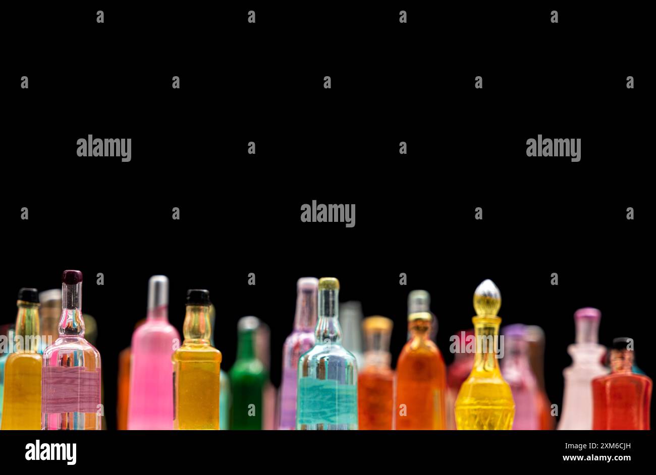 various miniature bottles of alcohol without labels with black ...