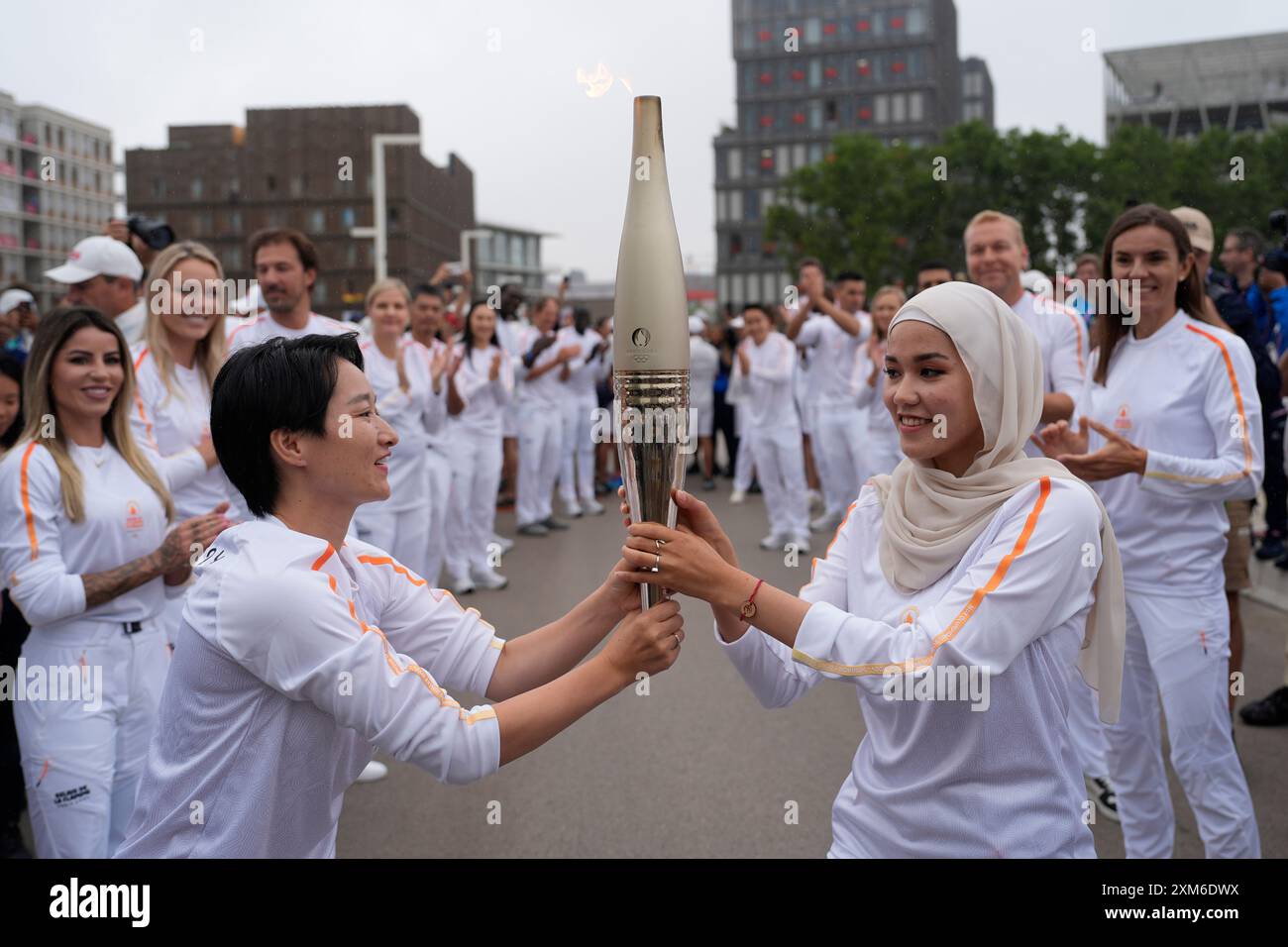 China's Wu Jingyu hands over the Olympic torch to Masomah Ali Zara ...