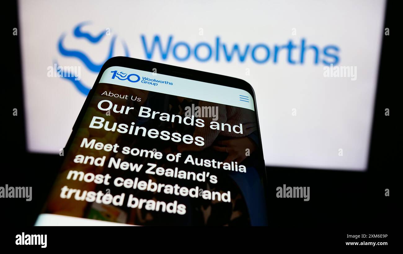 Mobile phone with webpage of Australian retail company Woolworths Group ...