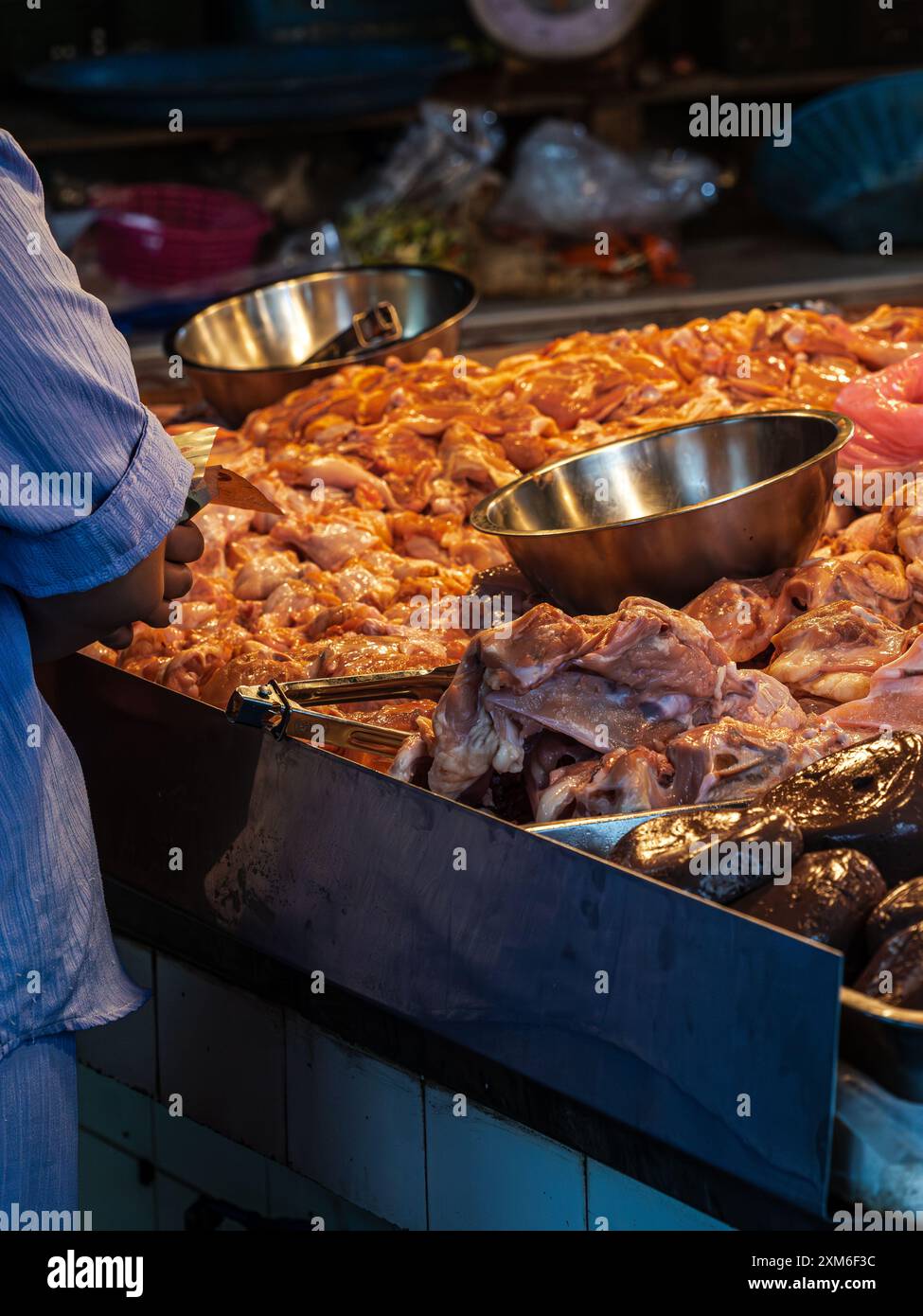 A large display of raw chicken, pork sits on a metal counter Stock ...