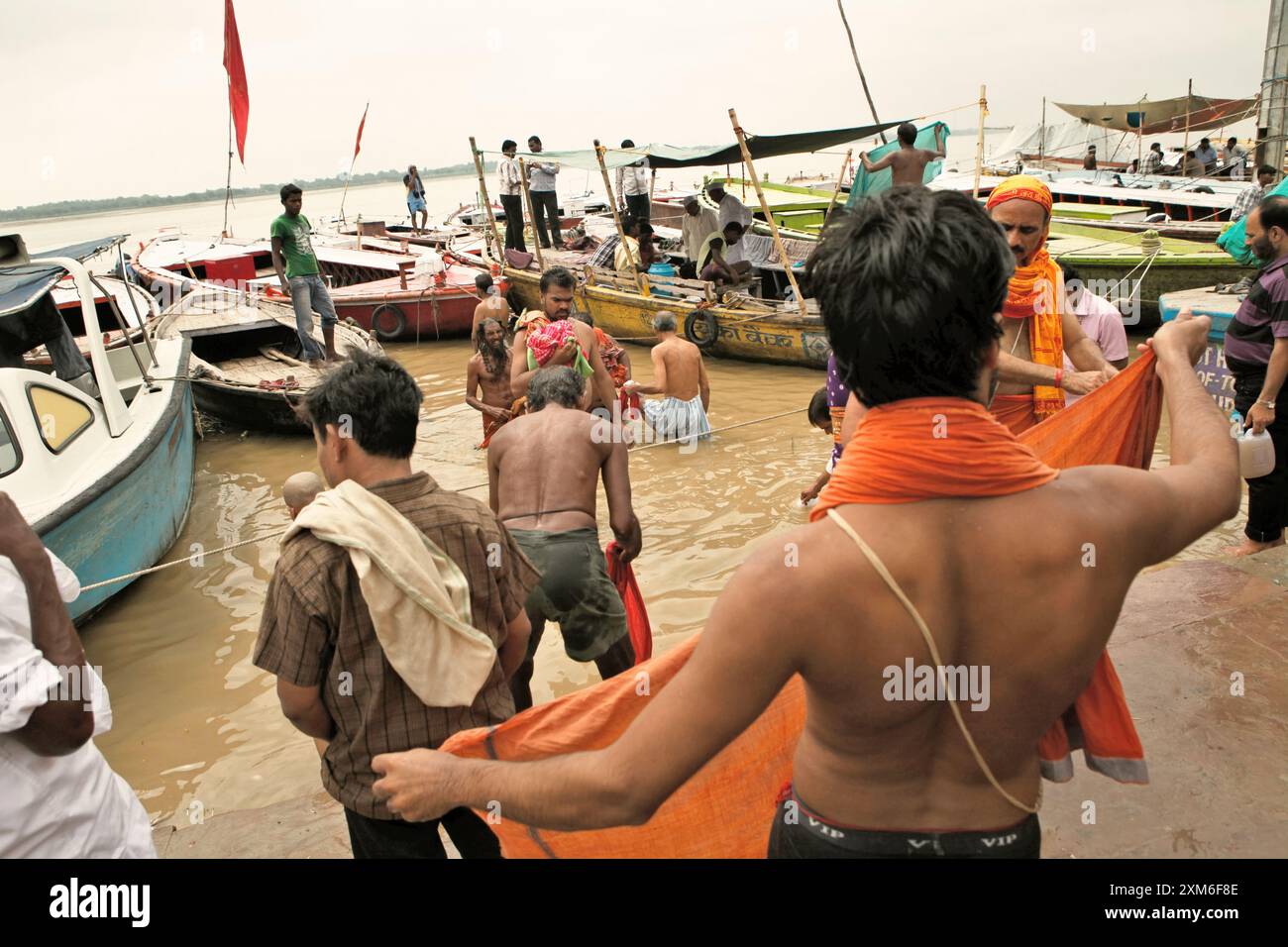 Pilgrims stand on the side of Ganges river when it is flooding, as they ...