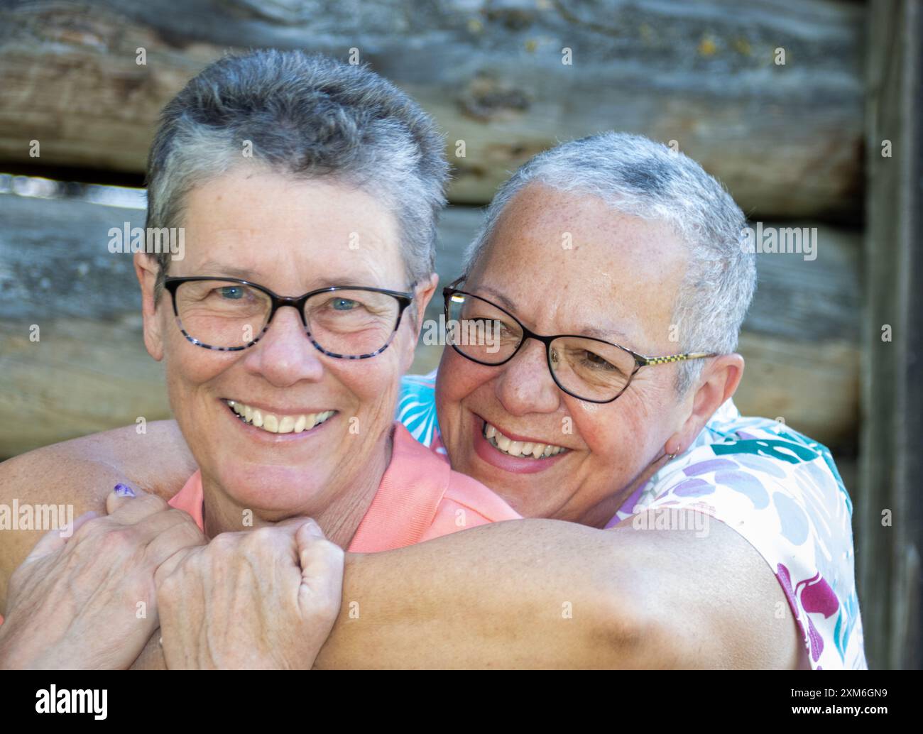 Happy older gay couple with glasses hugging and smiling Stock Photo - Alamy