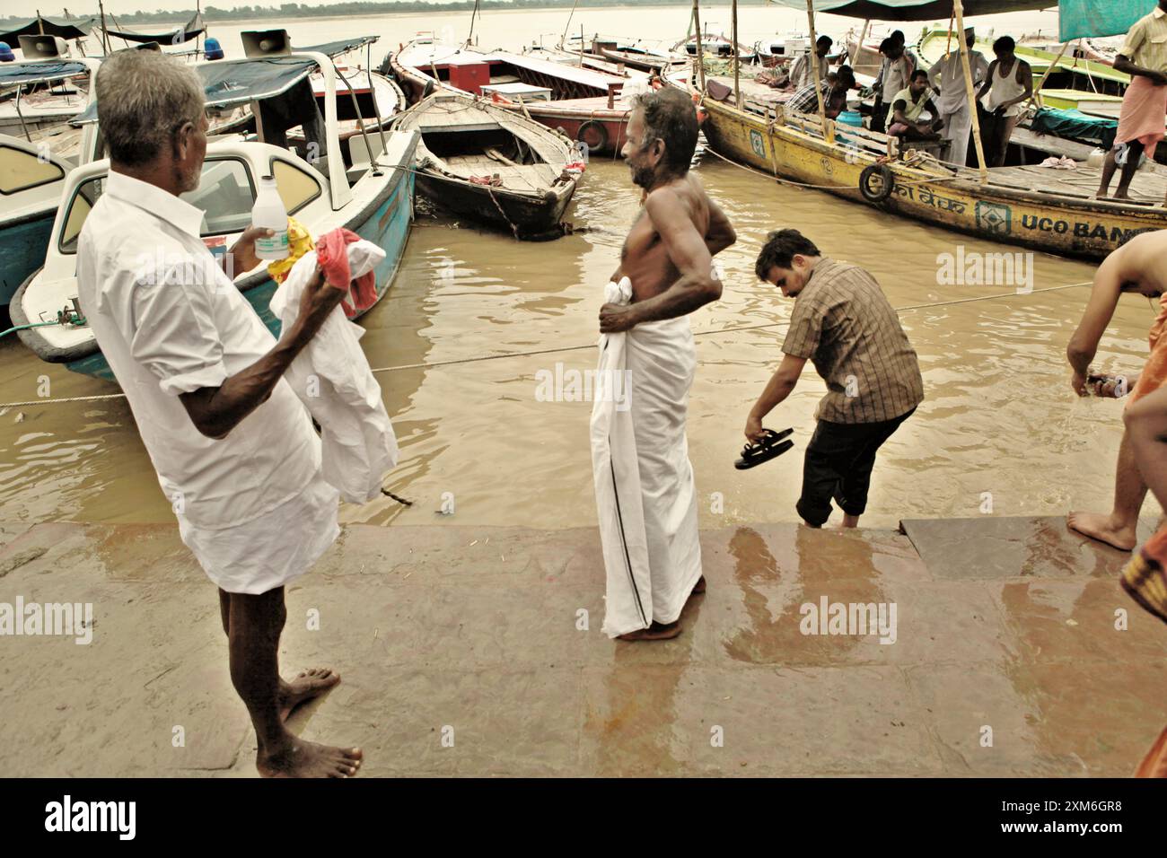 Pilgrims stand on the side of the river after wash themselves during a ...