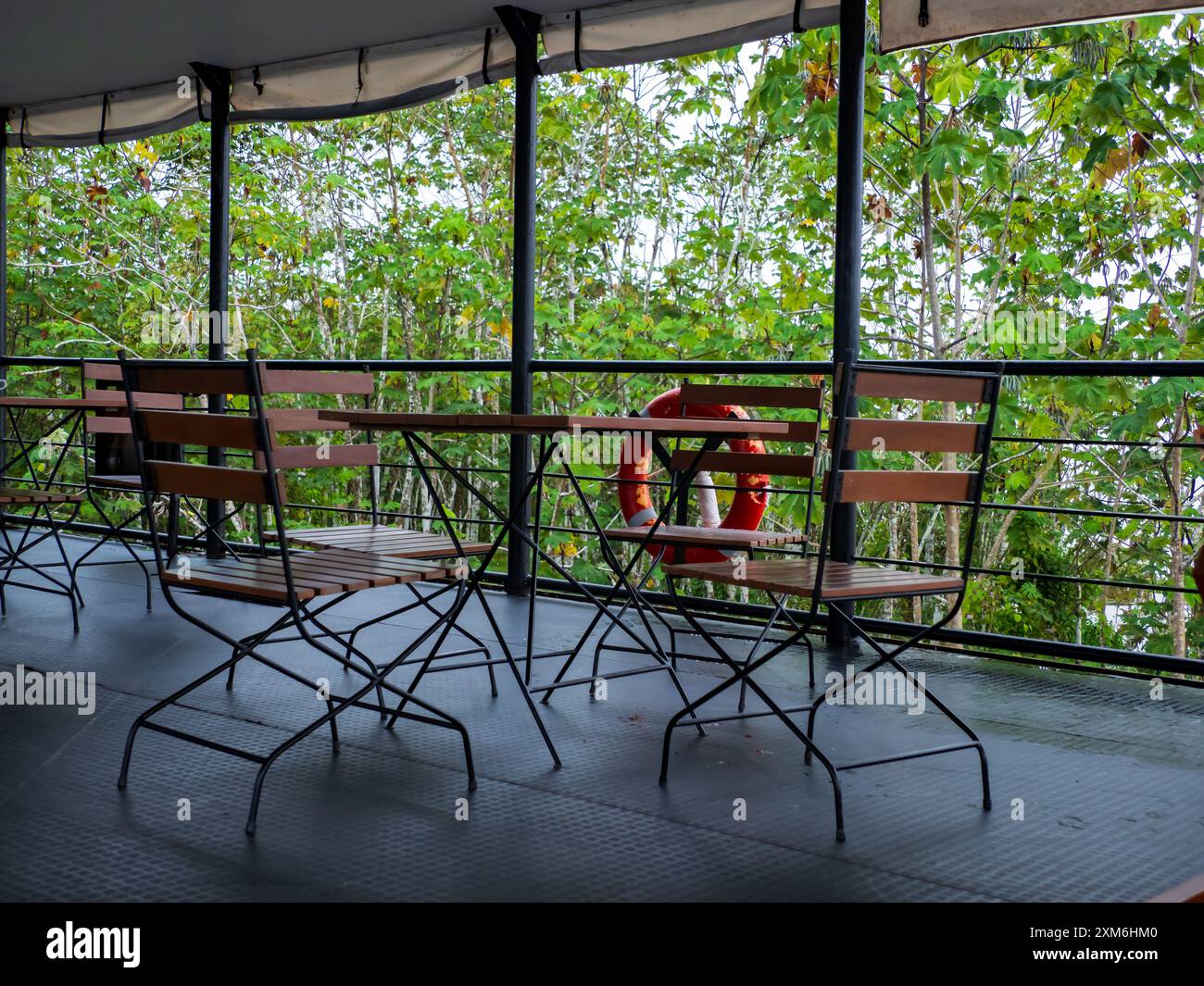 Deck of a luxury tourist ship cruising the Amazon basin with loungers ...