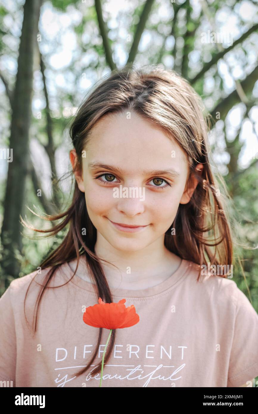 Little girl and poppy blossom Stock Photo - Alamy