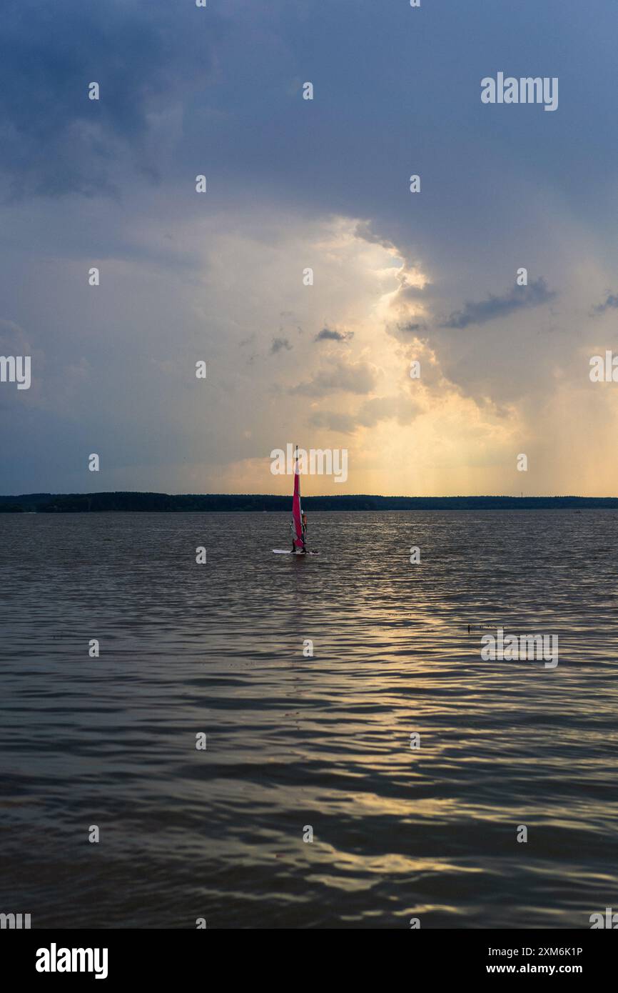 Windsurfing on a lake on a windy day Stock Photo - Alamy