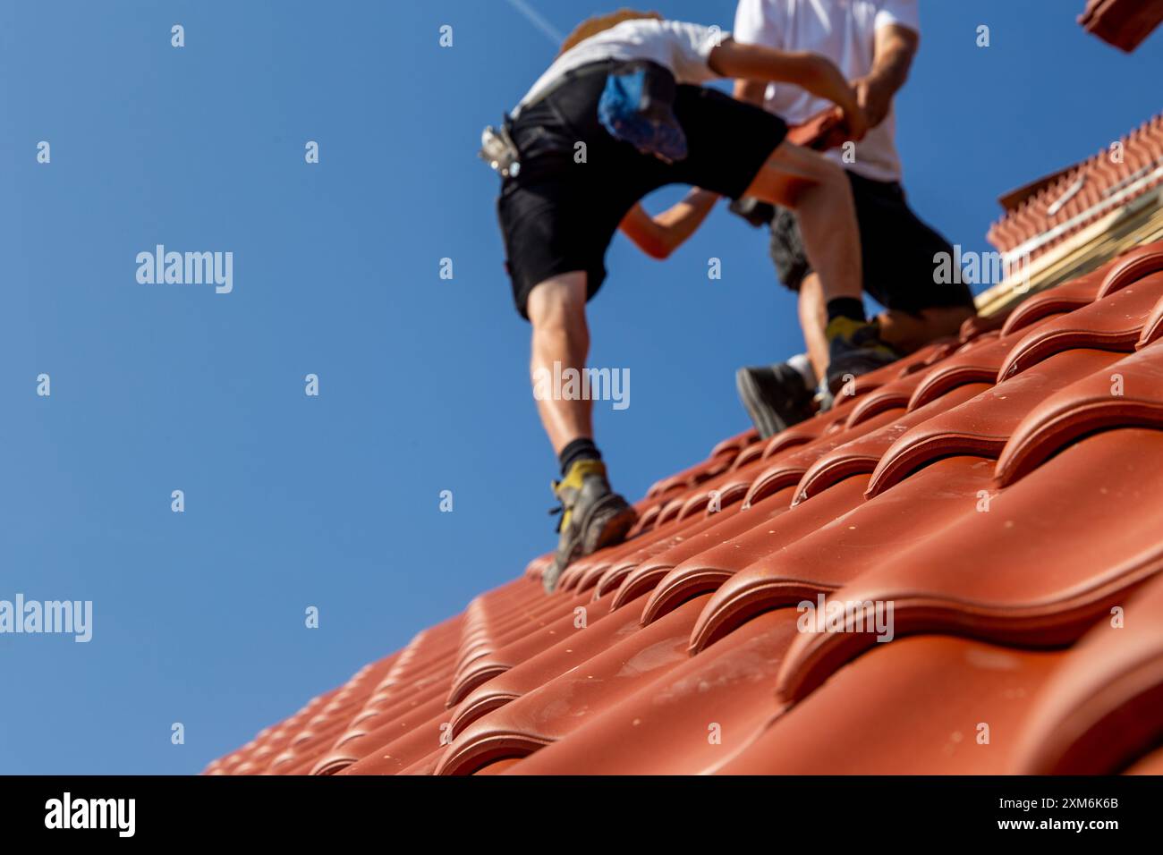 Roofing work, new covering of a tiled roof Stock Photo - Alamy