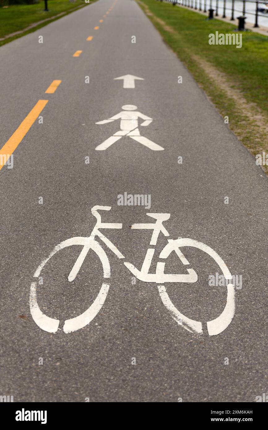 White Bicycle and Pedestrian Symbols on a Paved Path Stock Photo - Alamy