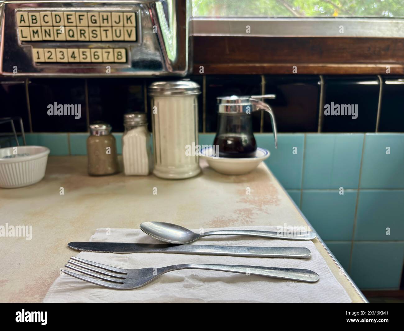 Classic American diner table with utensils, syrup, sugar, jukebox Stock ...