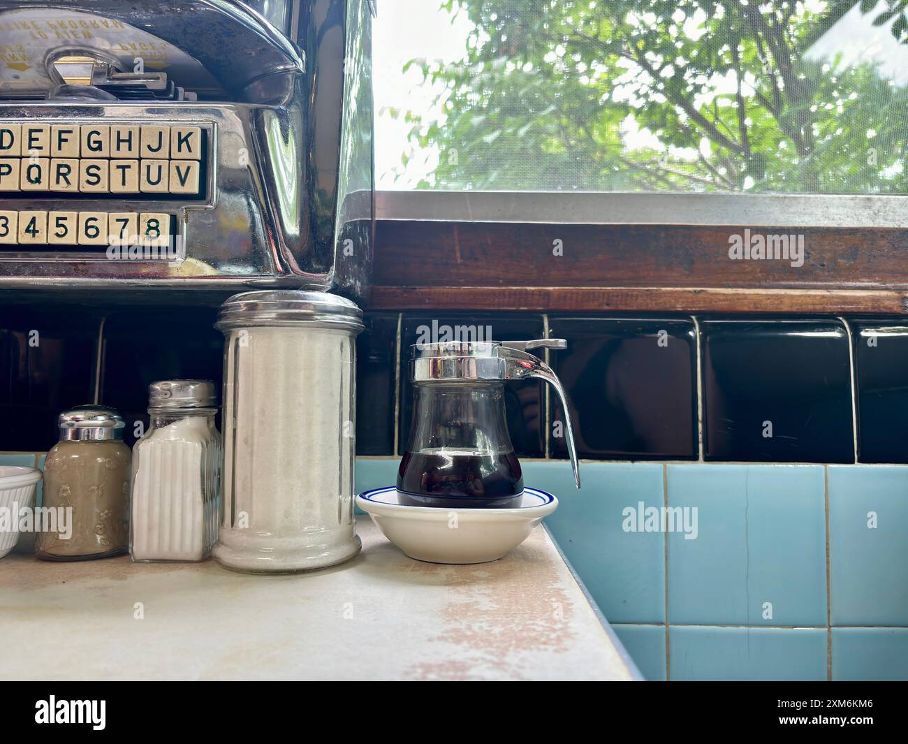 Classic American diner table with syrup, sugar, jukebox, tiles Stock ...