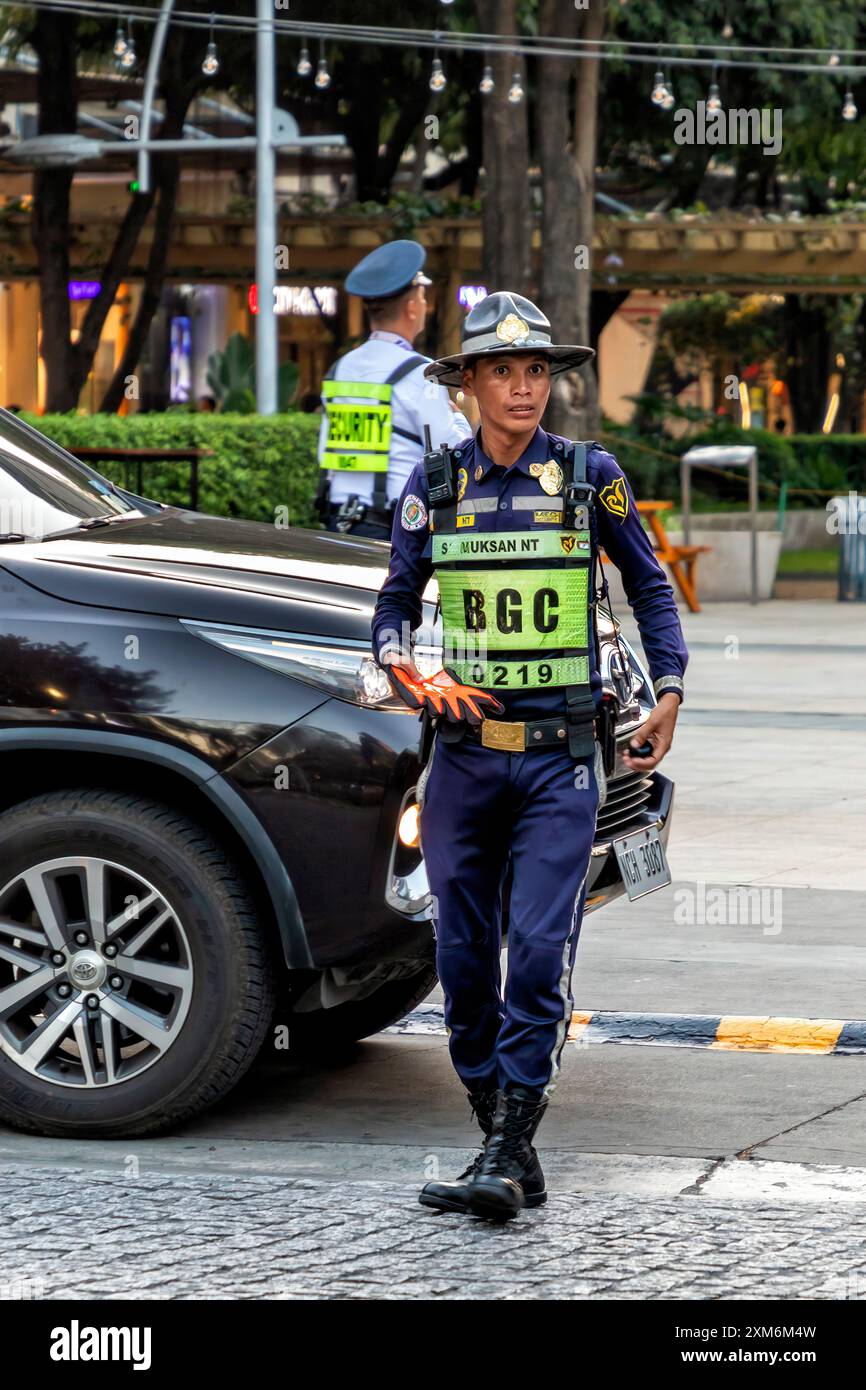 Traffic marshal controling vehicle movements, Bonifacio Global City ...
