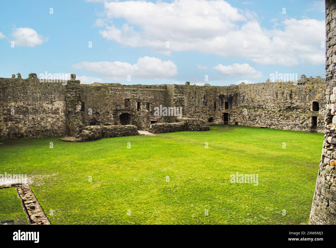 Beaumaris castle Anglesey wales with view over Snowdonia mountain range ...