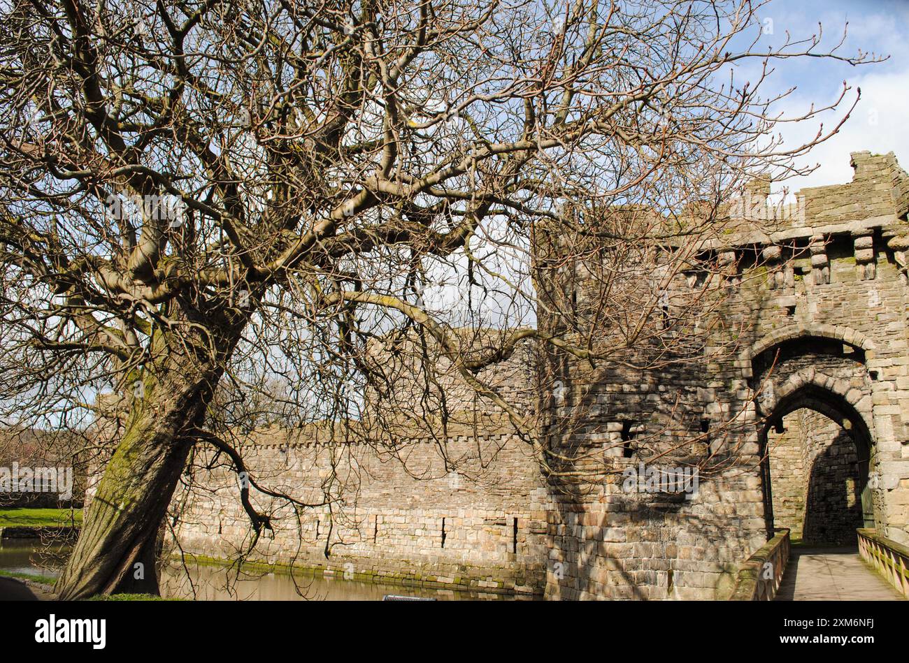Beaumaris castle Anglesey wales with view over Snowdonia mountain range ...