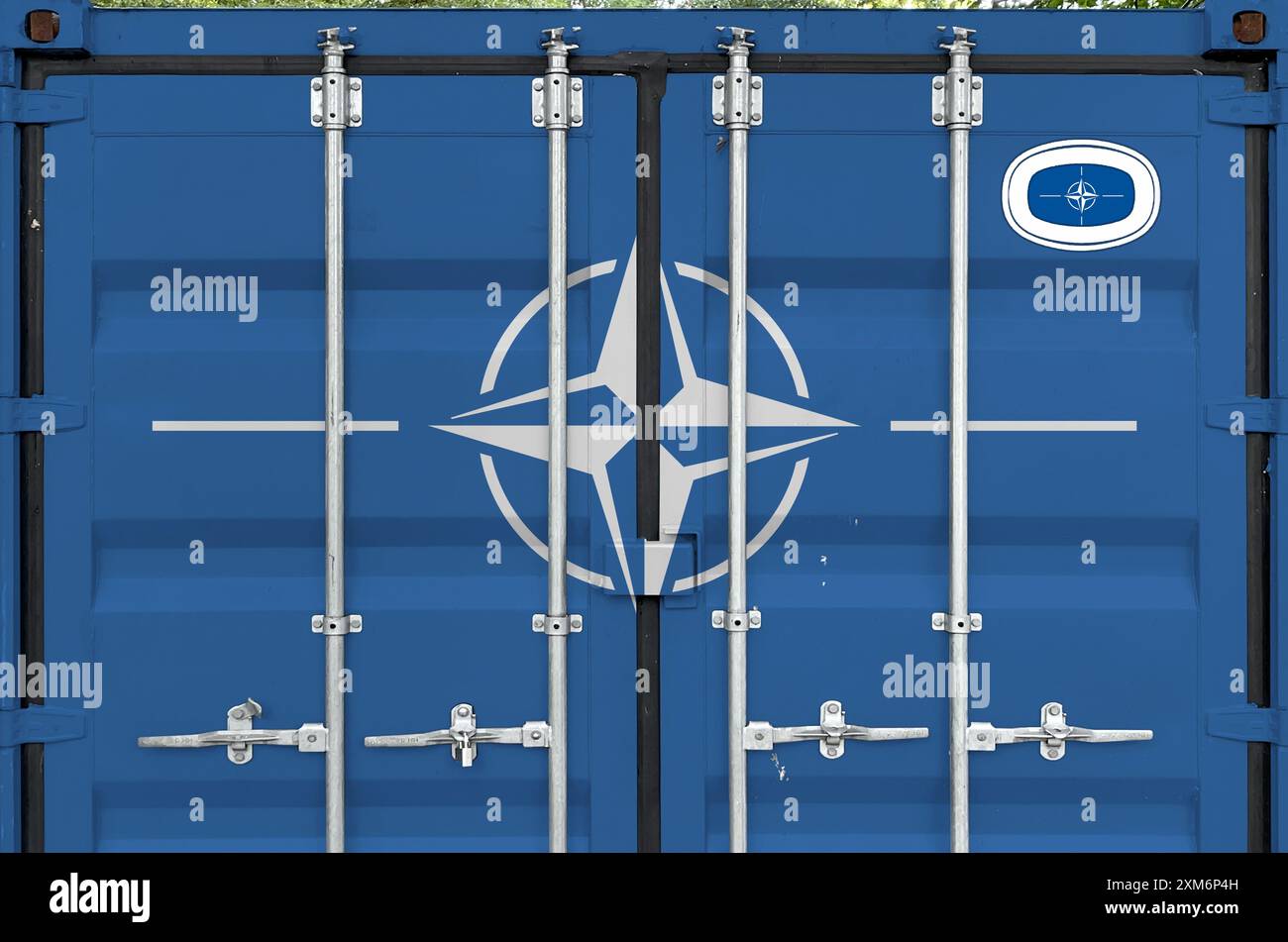 Nato flag depicted on metal doors of shipping cargo container outdoors ...