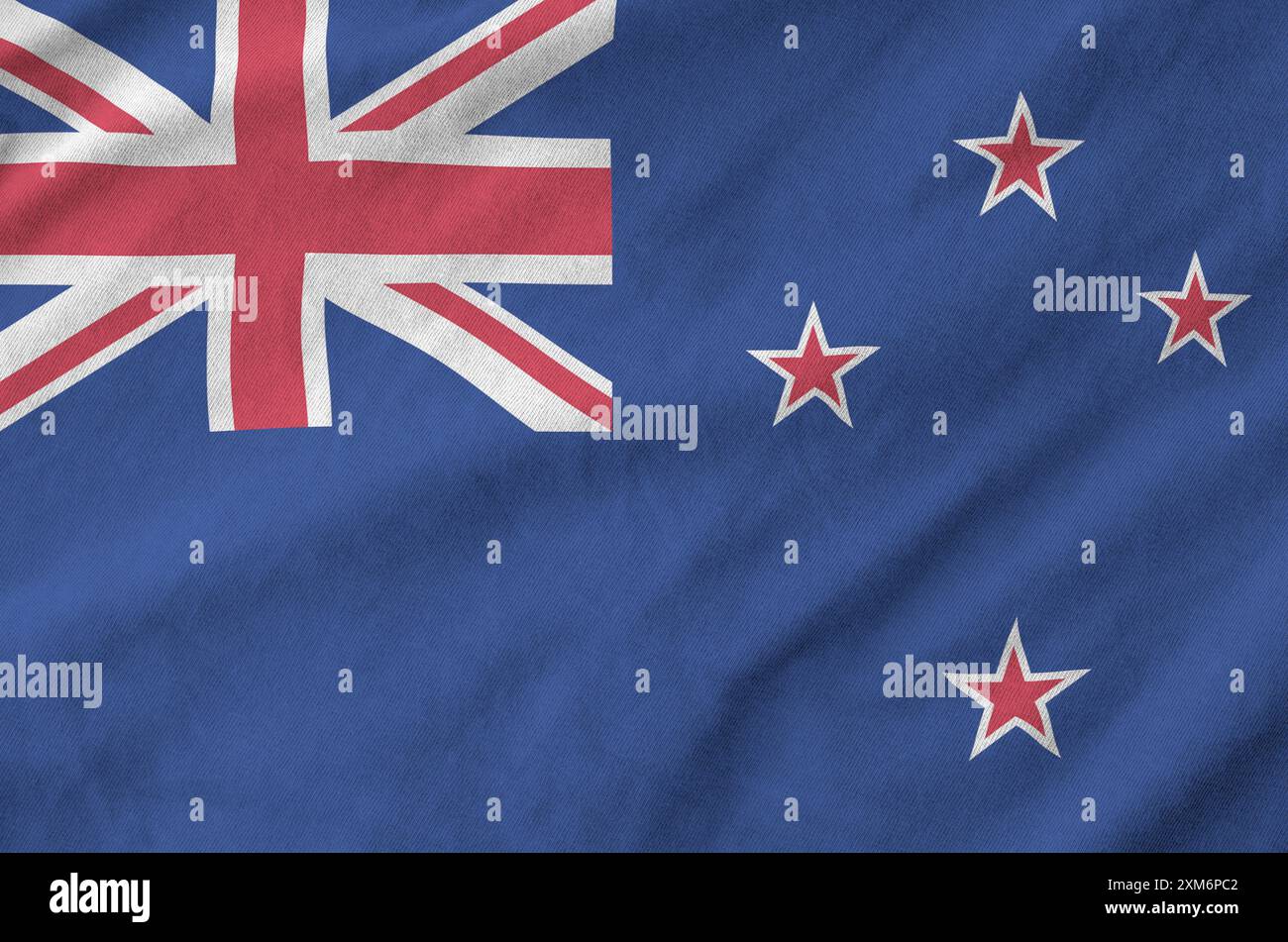 New Zealand flag depicted on folded wavy fabric of old cloth close up ...
