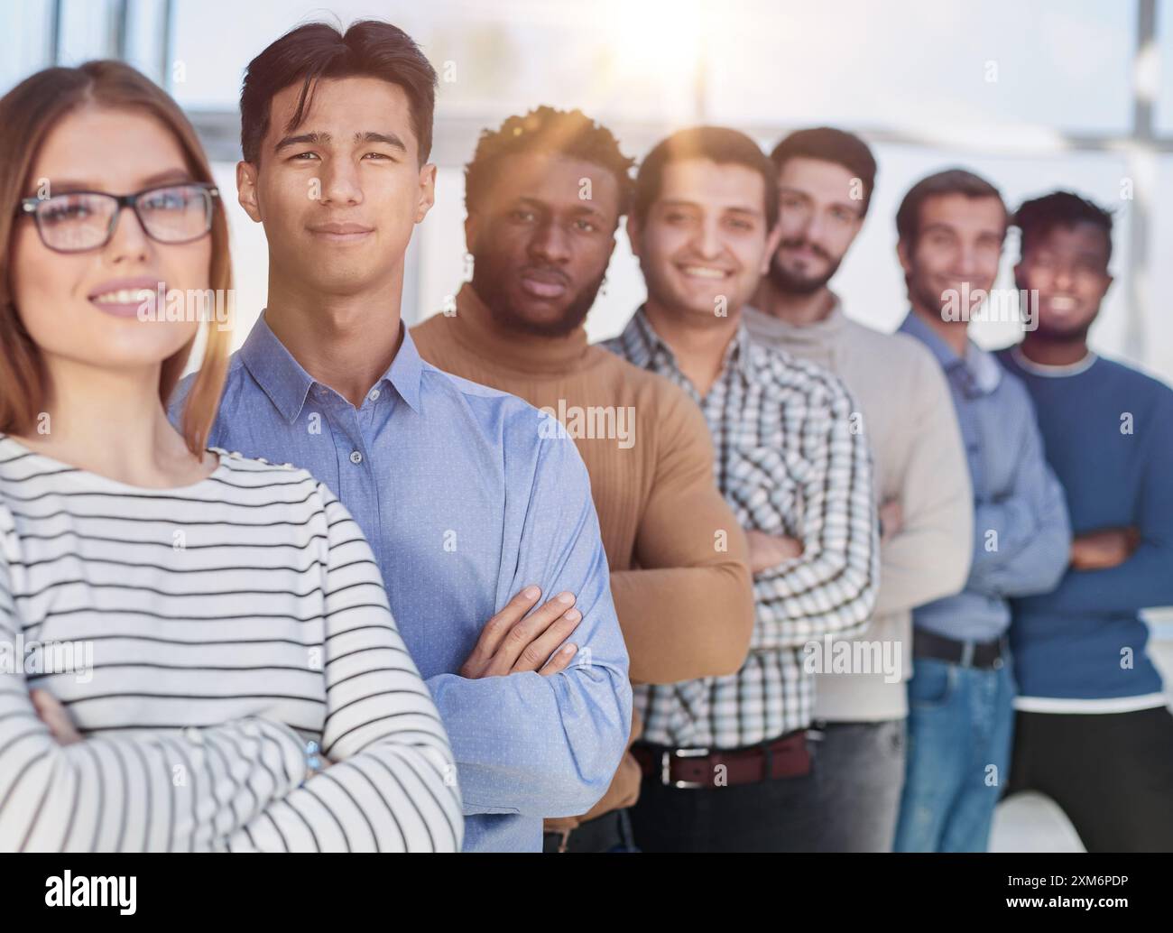 Portrait of multicultural office staff standing in the lobby in a row ...