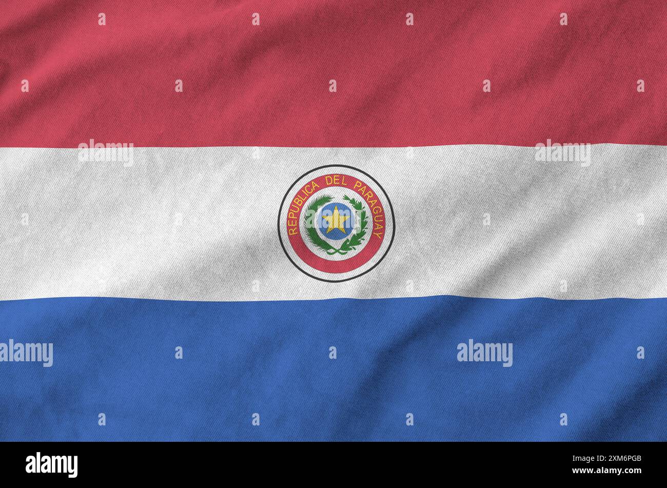 Paraguay flag depicted on folded wavy fabric of old cloth close up ...
